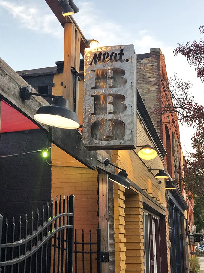 Meat BBQ's illuminated sign cuts through the evening darkness like a bat signal for hungry carnivores. The name says it all!