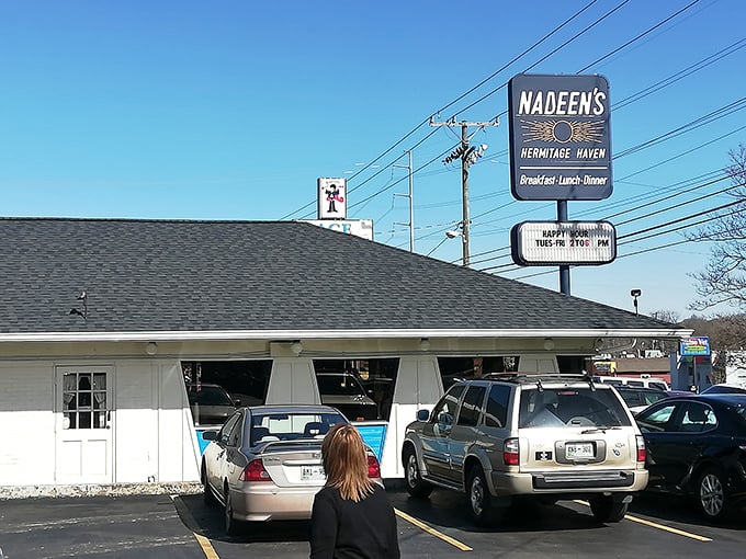 That retro blue-and-stone exterior with the sunrise logo promises the holy trinity: "Breakfast-Lunch-Dinner." Nadeen's delivers all three beautifully.