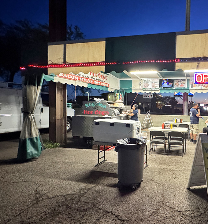 Nogales Hot Dogs looks like a movie set where the star is a bacon-wrapped masterpiece. Those "Go Cats" banners show they're true Tucson locals.