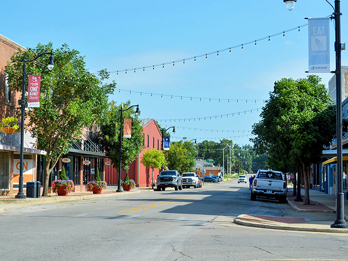 Paragould's Main Street strings lights across possibility. The kind of place where your dollar stretches further than those charming overhead bulbs.