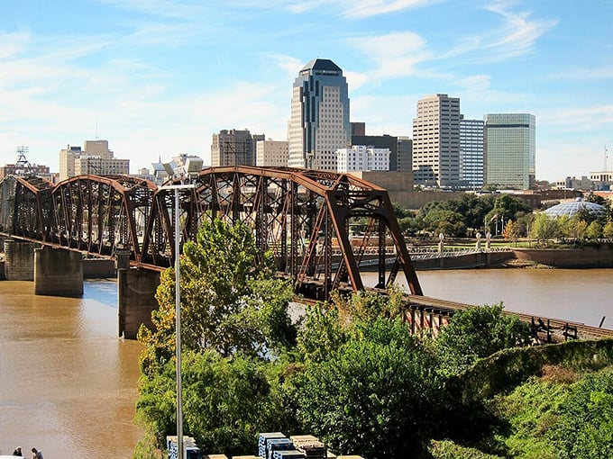 That rusty railroad bridge has seen Shreveport transform from river port to modern city. The Red River flows beneath, carrying centuries of stories.