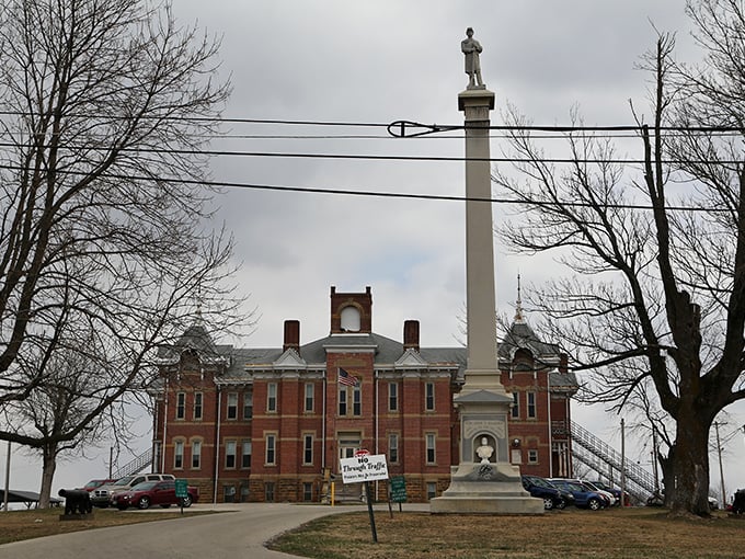 Historic Adams County courthouse in West Union with its distinctive monument and red brick architecture.