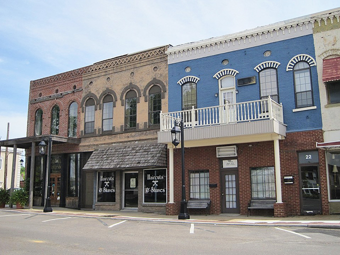 Historic buildings with colorful facades line Brownsville's charming downtown square, showcasing classic small-town Tennessee architecture.
