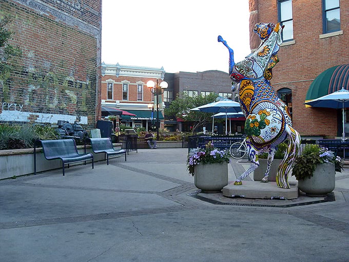 Art meets architecture in this Fort Collins courtyard, where a colorful mosaic sculpture adds whimsy to the brick-lined plaza.