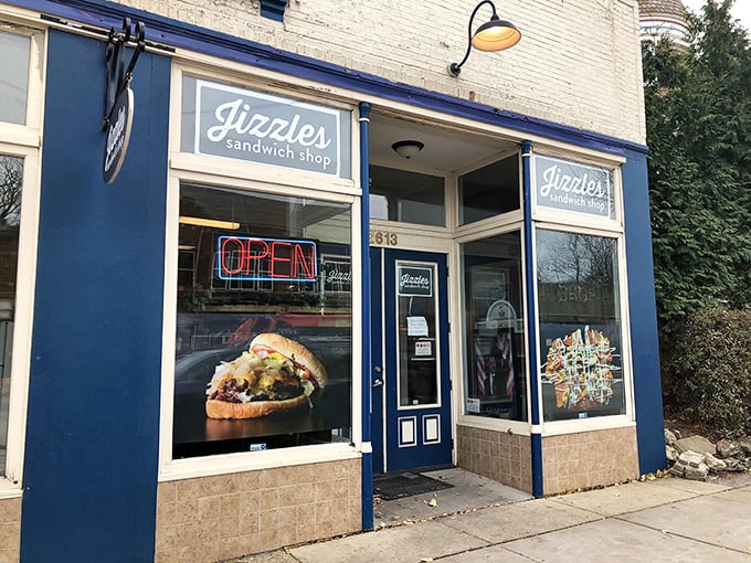 Behind that bright blue storefront lies sandwich magic. The neon "OPEN" sign is the green light to flavor town.