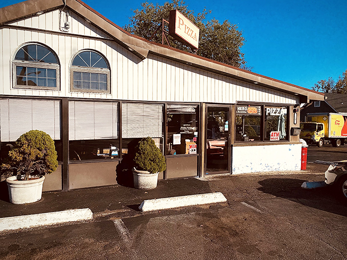 Soft light bathes Lodi Pizza's simple white exterior. Sometimes the most unassuming places guard the most delicious secrets.