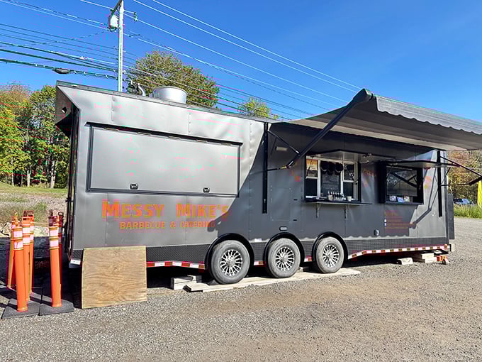 BBQ on wheels never looked so good. Messy Mike's sleek black trailer is like the Batmobile for brisket enthusiasts.