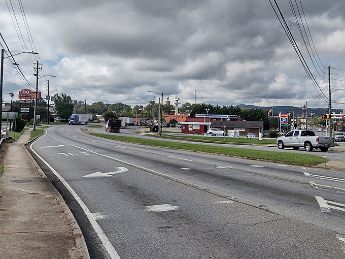 Storm clouds gather over Rome, Georgia's outskirts, where mountains peek through the distance beyond everyday commerce. Photo credit: Samir Araujo