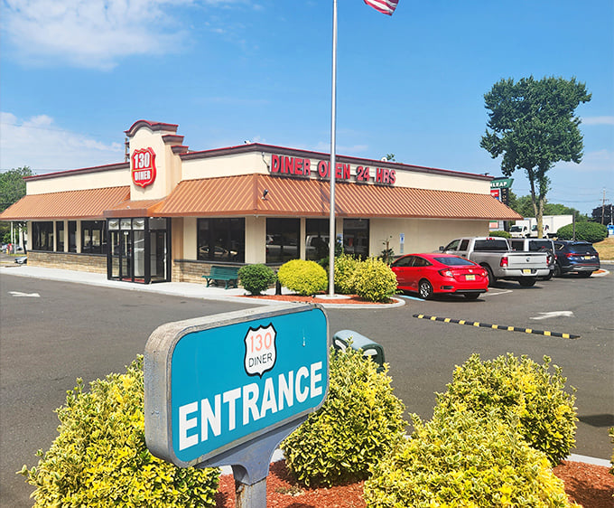 The classic roadside charm of Route 130 Diner shines under blue skies – where your coffee cup never stays empty for long.