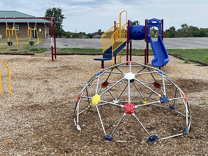 Modern fun meets small-town charm at Anderson Dean Park, where kids can climb, swing, and slide while parents reminisce about playgrounds before safety regulations.