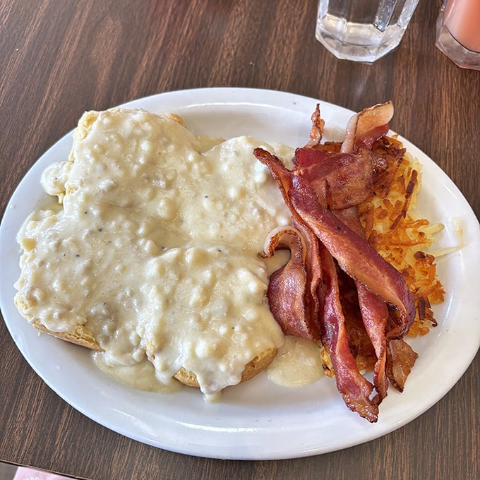 Biscuits swimming in creamy gravy alongside perfectly crisped bacon. This plate doesn't just say good morning&mdash;it belts it out like a Broadway musical.
