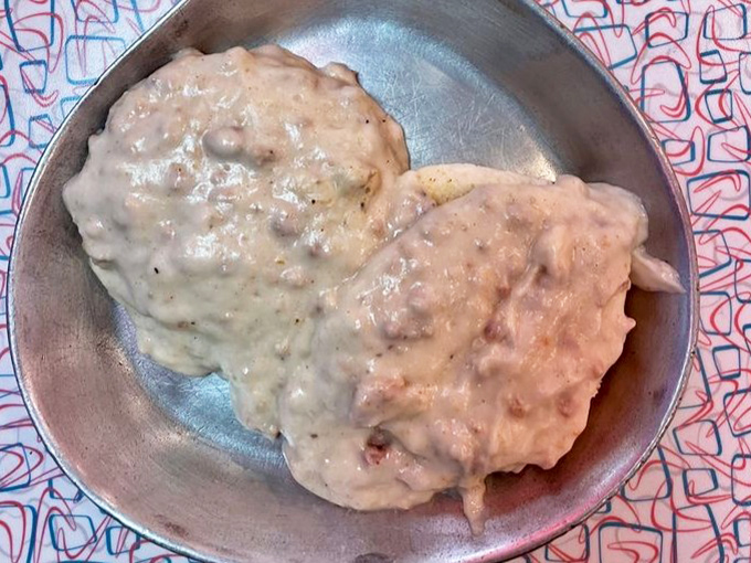 Behold the holy grail of comfort food: biscuits swimming in a sea of peppery sausage gravy that could make even your cardiologist secretly jealous.