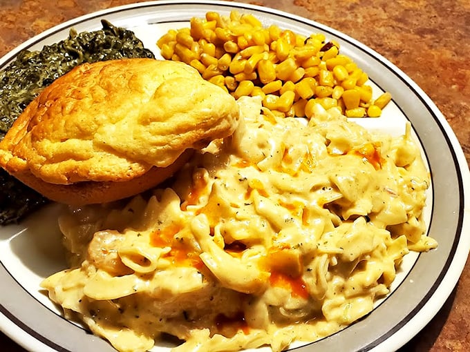 Southern comfort on a plate: golden biscuit, creamy scrambled eggs, sweet corn, and greens&mdash;a breakfast symphony that hits all the right notes.