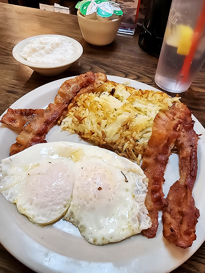 Breakfast perfection doesn't need filters—just perfectly cooked eggs, crispy bacon, and hash browns that strike the ideal balance between crisp and tender.