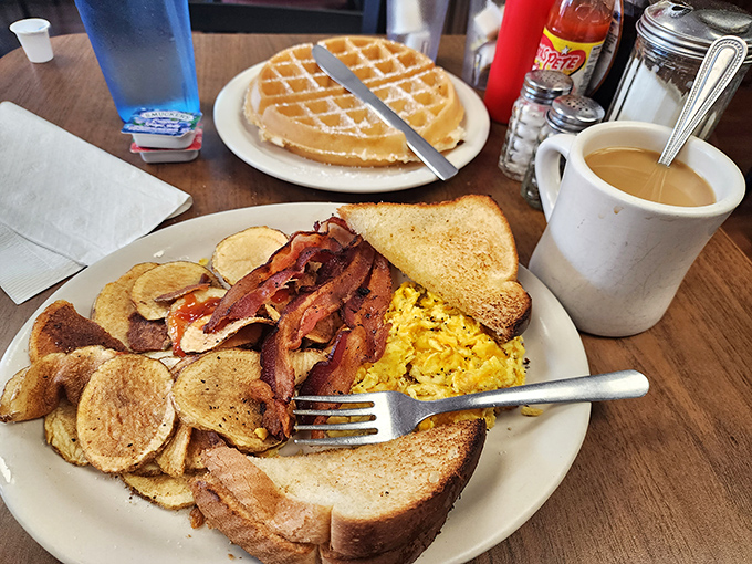 Breakfast nirvana achieved: golden home fries, perfectly scrambled eggs, crispy bacon, and toast&mdash;the four food groups of morning happiness.