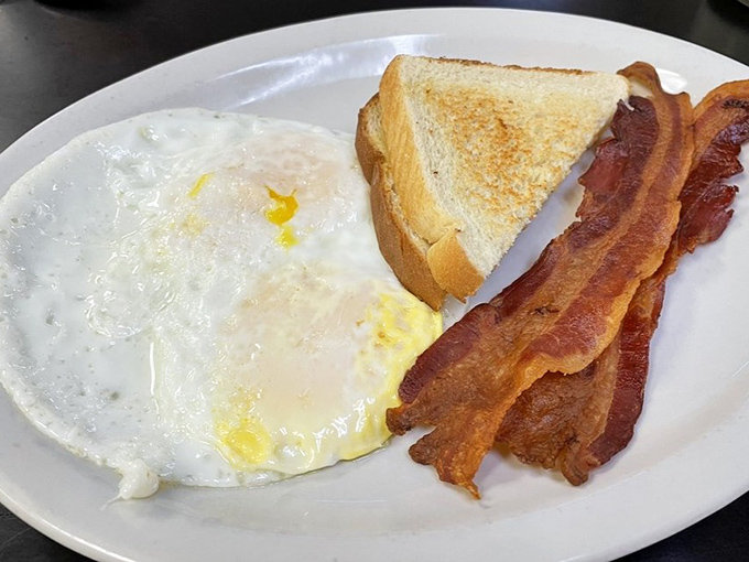 Sunny-side perfection meets crispy bacon in this breakfast trinity&mdash;proof that sometimes the simplest combinations create the most profound satisfaction.