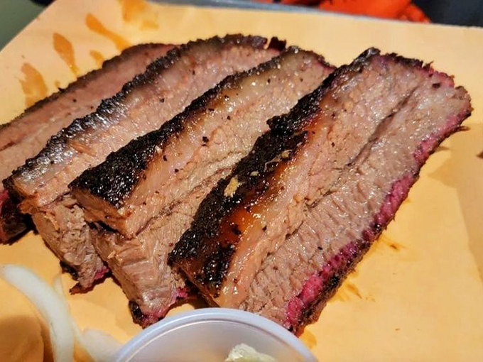Behold the holy grail of BBQ – brisket with that perfect pink smoke ring that whispers, "Someone here really knows what they're doing."