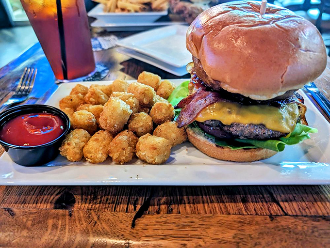 Behold, the perfect burger in its natural habitat&mdash;juicy, cheese-draped, and accompanied by golden tater tots standing at attention.