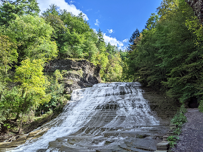 Buttermilk Falls cascades down layered rock like nature's own wedding cake, minus the fondant and family drama.