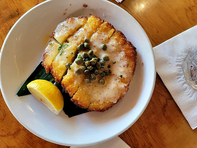 The star of the show: calamari steak that's tender, golden, and topped with capers. This isn't your average rubbery squid rings.