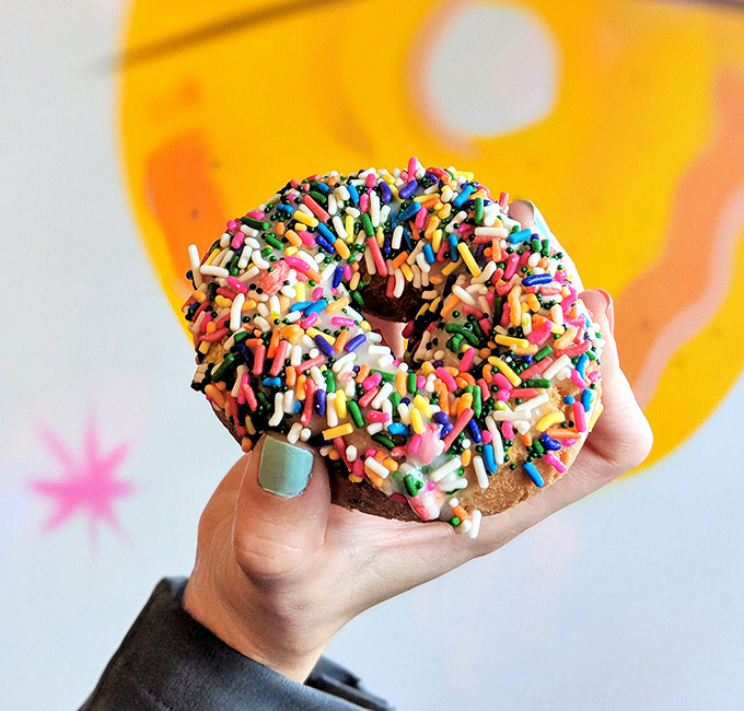 This sprinkle-covered masterpiece isn't just a donut—it's a celebration wearing a party hat, ready to dance on your taste buds.