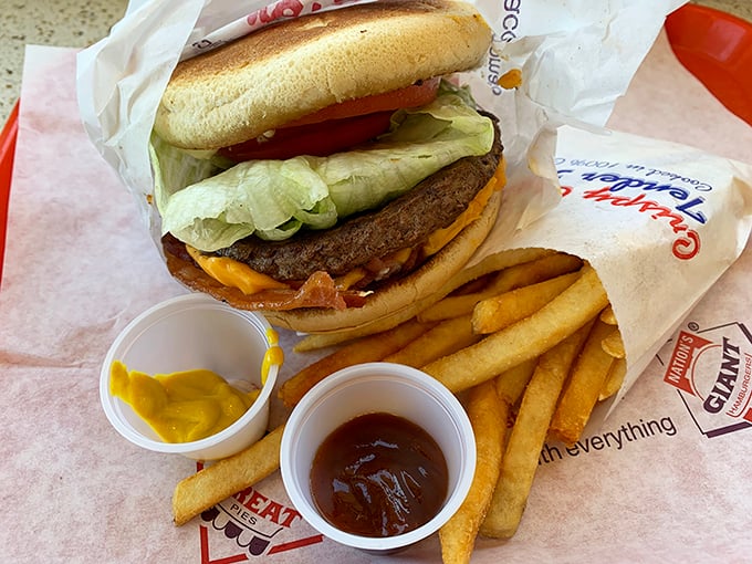 Behold the cheeseburger that requires strategic planning, two hands, and possibly a structural engineer to navigate successfully.