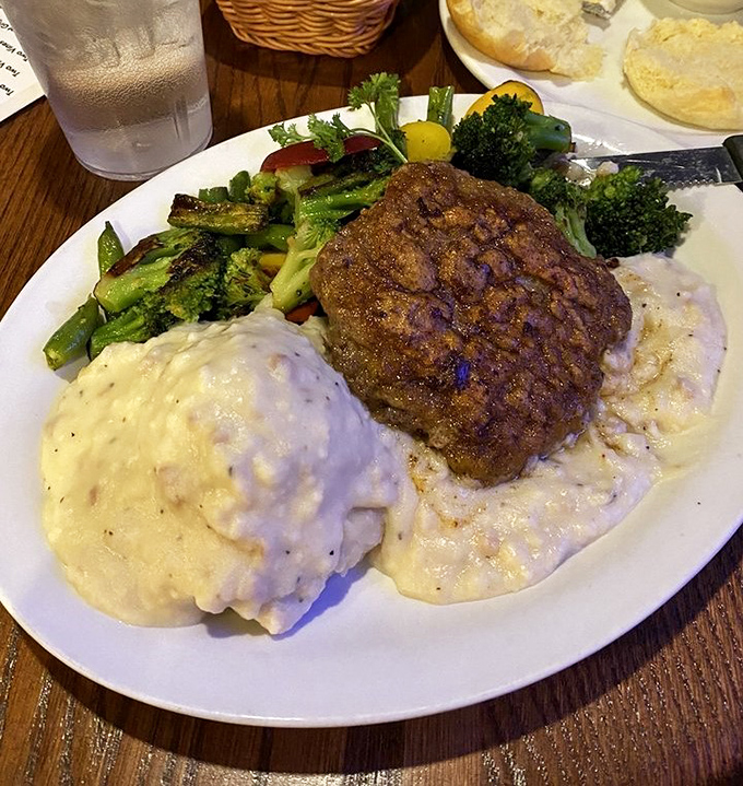 Behold the crown jewel: chicken fried steak swimming in country gravy with mashed potatoes and vegetables pretending to make it healthy.