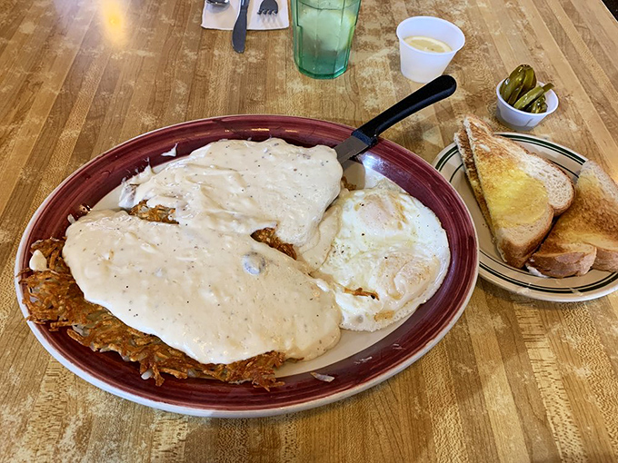 Behold the legendary chicken fried steak&mdash;crispy, smothered in peppery gravy, with eggs and toast standing by. Breakfast architecture at its finest!