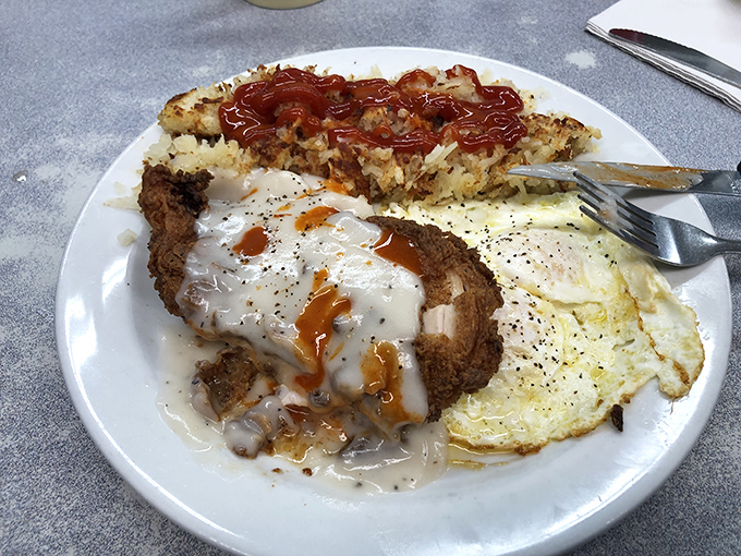 Country-fried chicken with gravy that cascades like a savory waterfall &ndash; this is the kind of breakfast that fuels mountain adventures or justified naps.