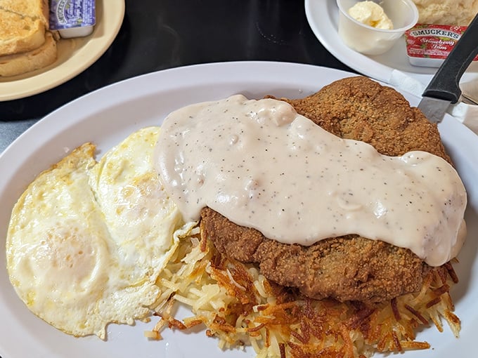 Country-fried steak smothered in peppery gravy alongside sunny-side-up eggs. This plate doesn't just speak comfort food&mdash;it sings it in perfect harmony.