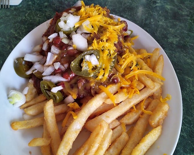 These loaded fries aren't just a side—they're a main event. Crispy potatoes crowned with chili, cheese, jalapeños, and enough toppings to require a fork.