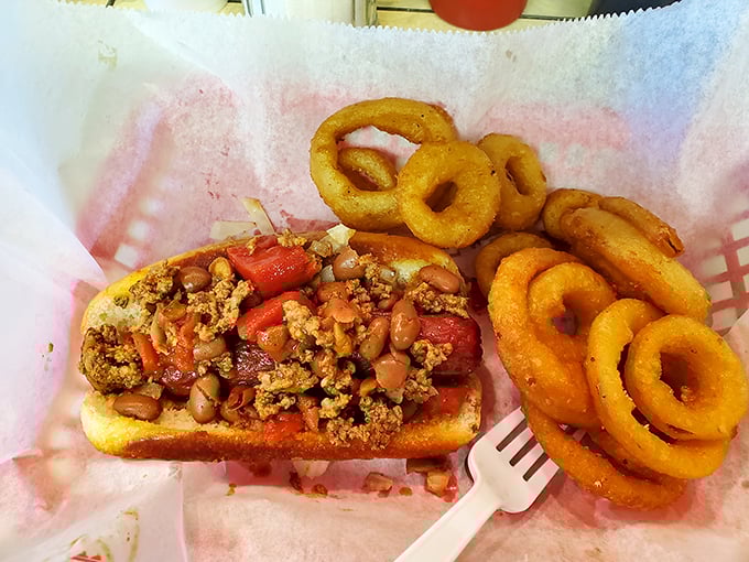 This isn't just a chili dog; it's a handheld flavor bomb with onion rings that shatter like delicate glass sculptures.
