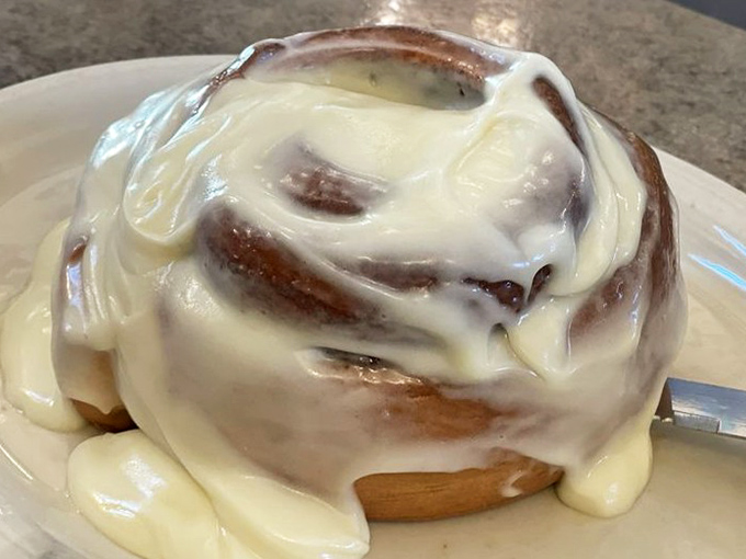 Not so much a cinnamon roll as a cinnamon continent, drowning gloriously in cream cheese frosting. Your diet plan's worst nightmare, your soul's best friend.