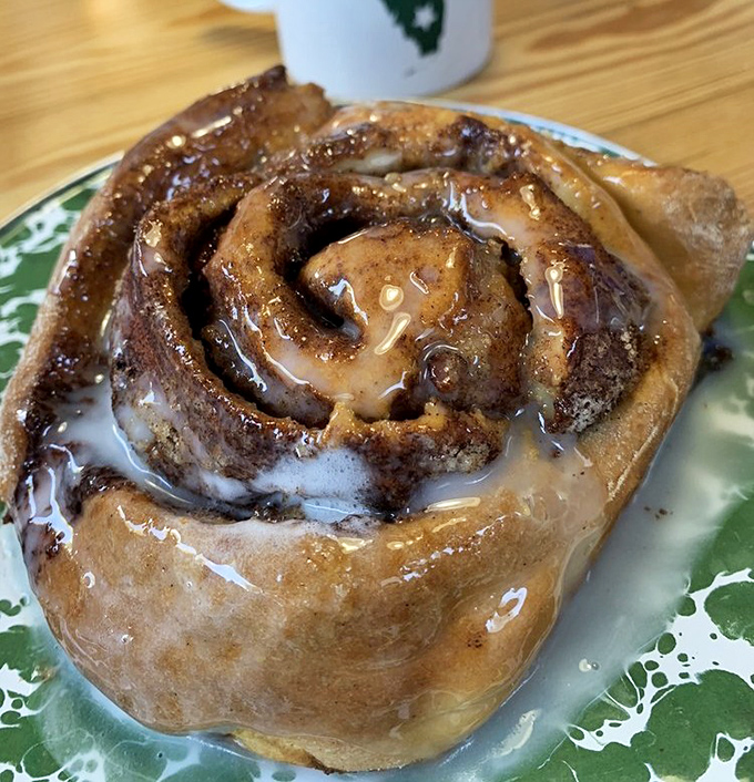 Behold the cinnamon roll that launched a thousand road trips. This spiral of joy has more layers than your favorite family drama, and twice the sweetness.