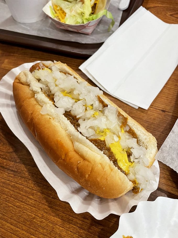 The Detroit Coney in all its glory &ndash; meat sauce, mustard, and onions creating a holy trinity of flavor that transcends its humble ingredients.
