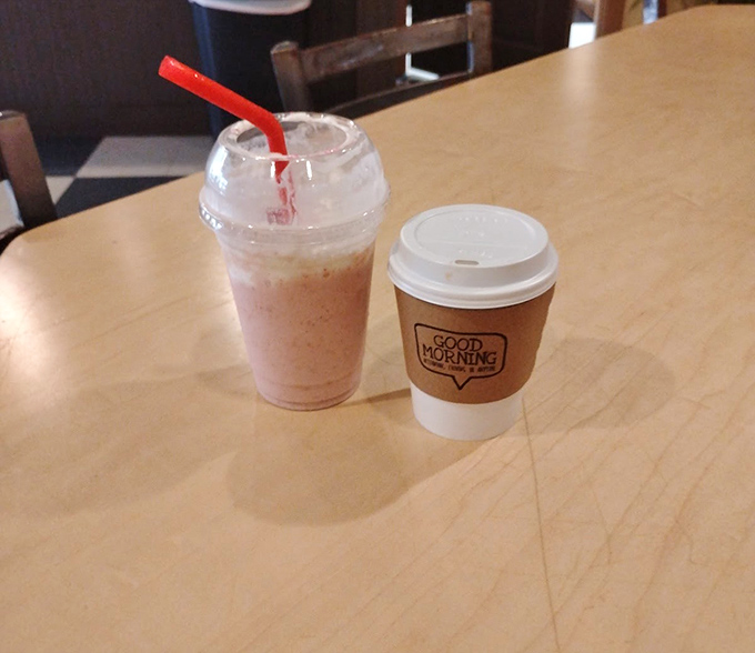 A frothy milkshake and steaming coffee await – the perfect companions for watching cats lounge in the adjacent room.