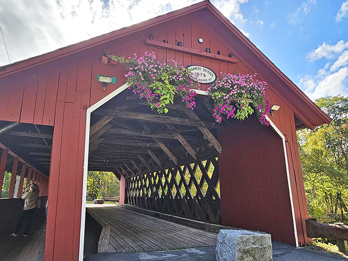 This crimson covered bridge isn't just Instagram bait&mdash;it's a time machine to simpler days, complete with hanging flower baskets that would make Martha Stewart swoon.
