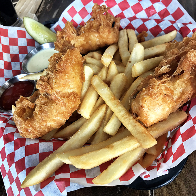 Golden-battered fish and chips that would make a Londoner weep with joy, served on that classic red checkered paper&mdash;seafood perfection in its most honest form.