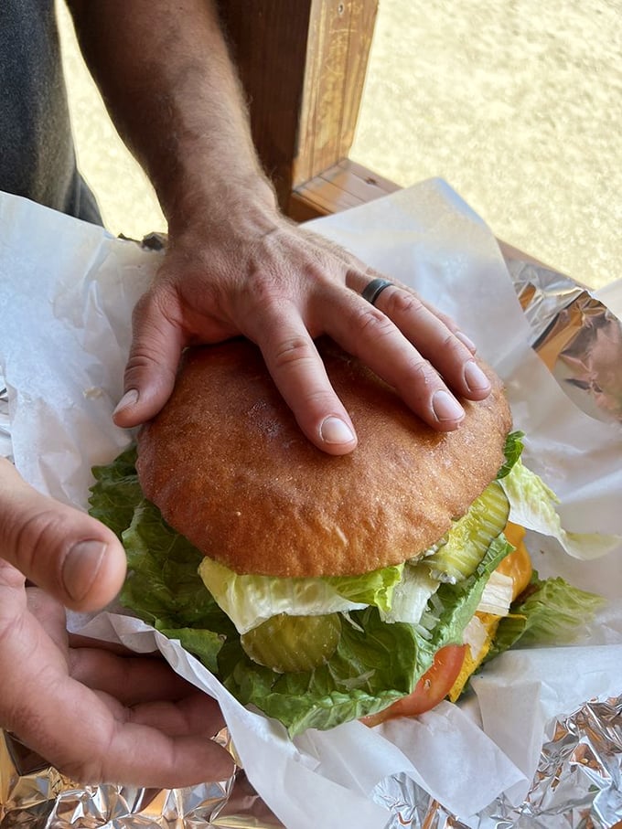Proof that size does matter! This burger requires a hand-to-bun ratio assessment before the first magnificent bite.