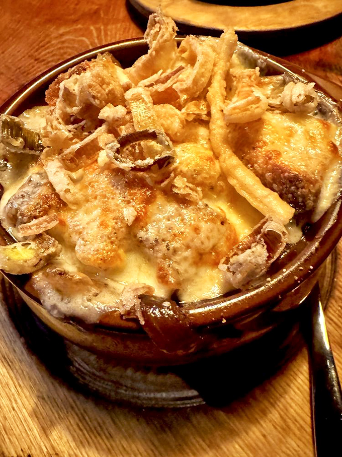 This isn't just French onion soup – it's a bubbling cauldron of joy with a cheese pull that deserves its own slow-motion soundtrack.