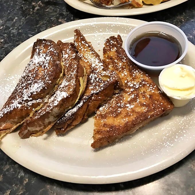 This French toast isn't just breakfast &ndash; it's an event. Golden-brown challah with a dusting of powdered sugar that makes every bite worth getting out of bed for.
