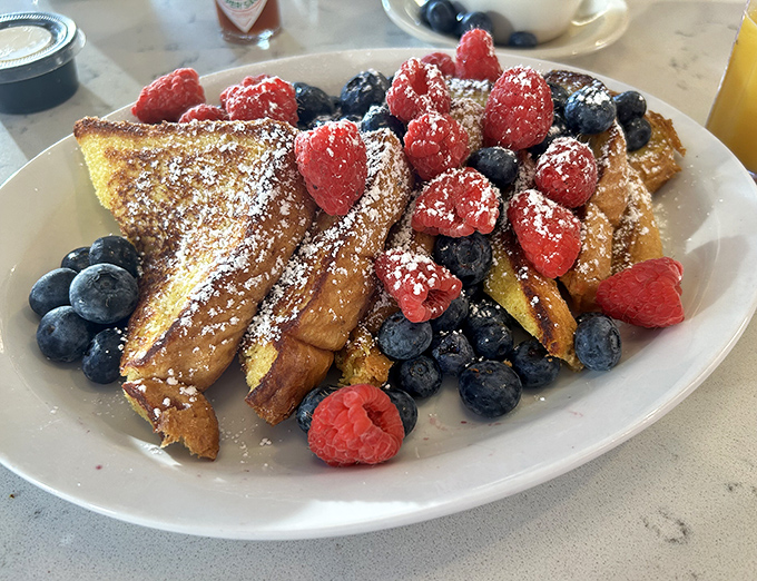 This French toast isn't just breakfast, it's an event&mdash;golden perfection crowned with fresh berries and a dusting of powdered sugar.