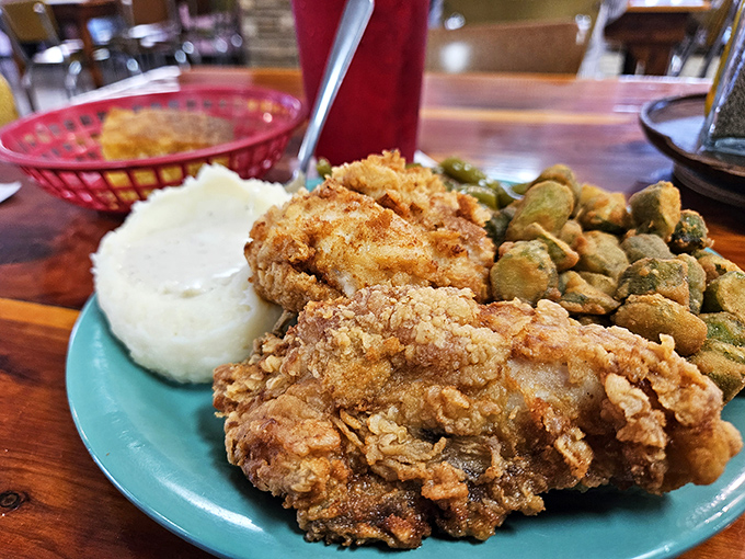 Golden-brown perfection on a turquoise plate &ndash; this fried chicken doesn't need fancy plating when it tastes like your grandmother's secret recipe.