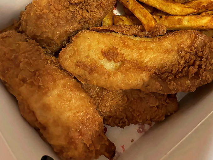 Golden-fried fish that shatters with each bite, revealing tender flakes within. This isn't just dinner; it's edible architecture at its finest.