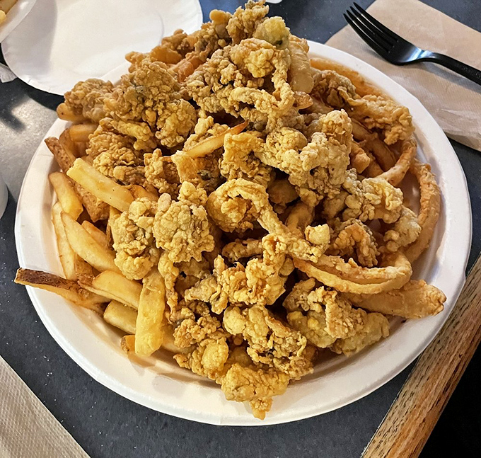 Golden treasure on a paper plate&mdash;whole belly clams piled high atop crispy fries, a Massachusetts birthright that tourists can only envy.