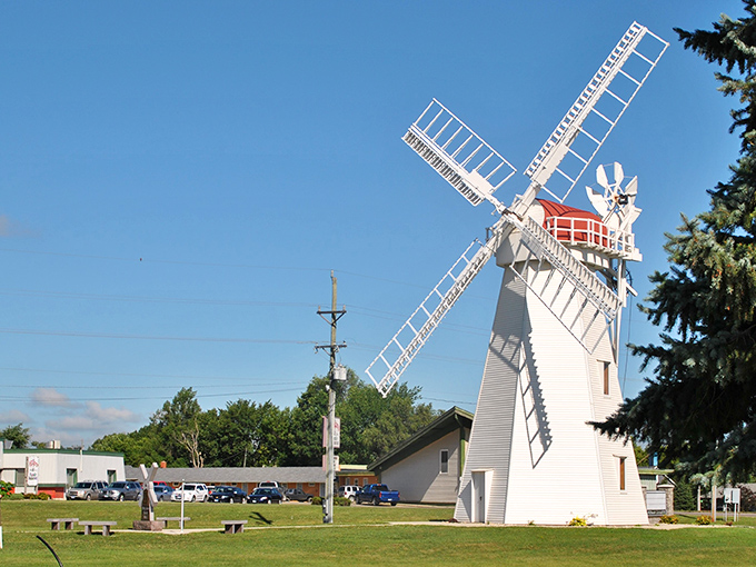 Holland's Grist Mill stands like a pristine sentinel, its white windmill arms ready to catch South Dakota's famous breezes.