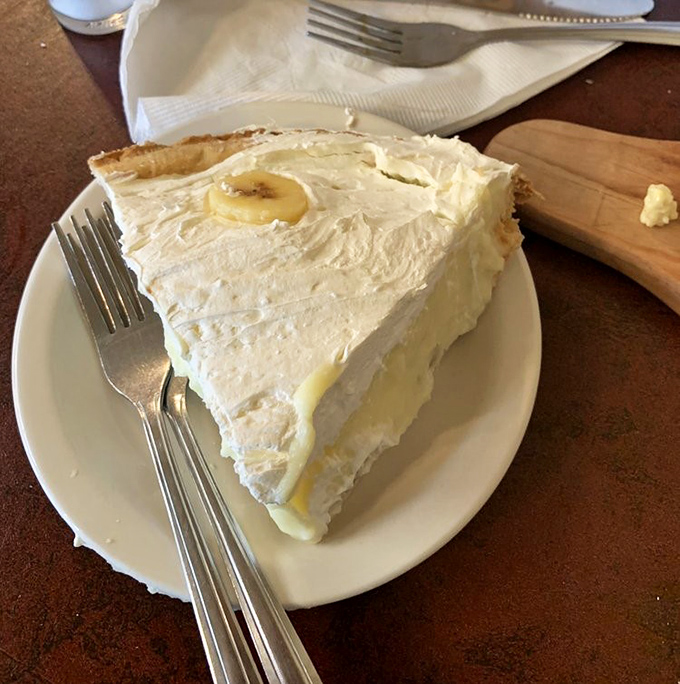 This banana cream pie isn't just dessert; it's a fluffy cloud of happiness that makes you question why you'd ever waste calories on lesser sweets.