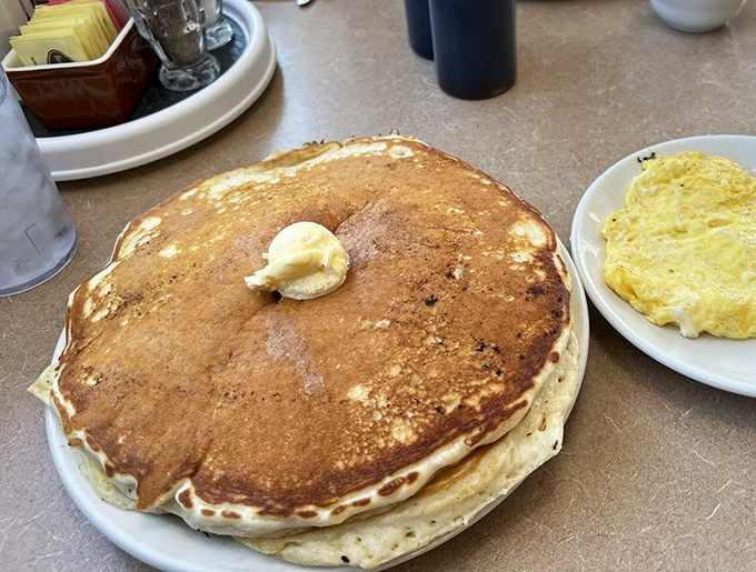 This pancake isn't just big, it's geographical. You could use GPS coordinates to navigate from the butter pat to the edges of this magnificent breakfast continent.