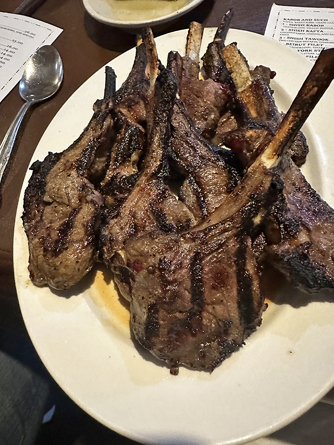 These aren't just lamb chops &ndash; they're meaty masterpieces with perfect char marks telling stories of flame-kissed perfection. The bone handles? Nature's utensils for civilized carnivores.