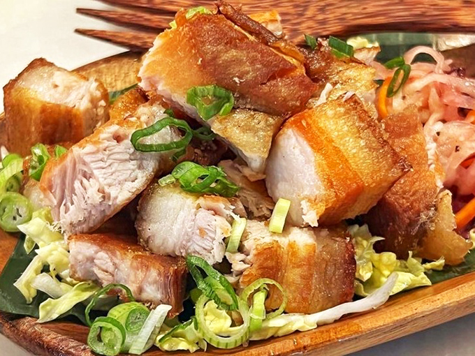 Crispy pork belly that shatters like glass before melting into tender, juicy meat &ndash; this lechon kawali doesn't just steal the show, it runs away with it.